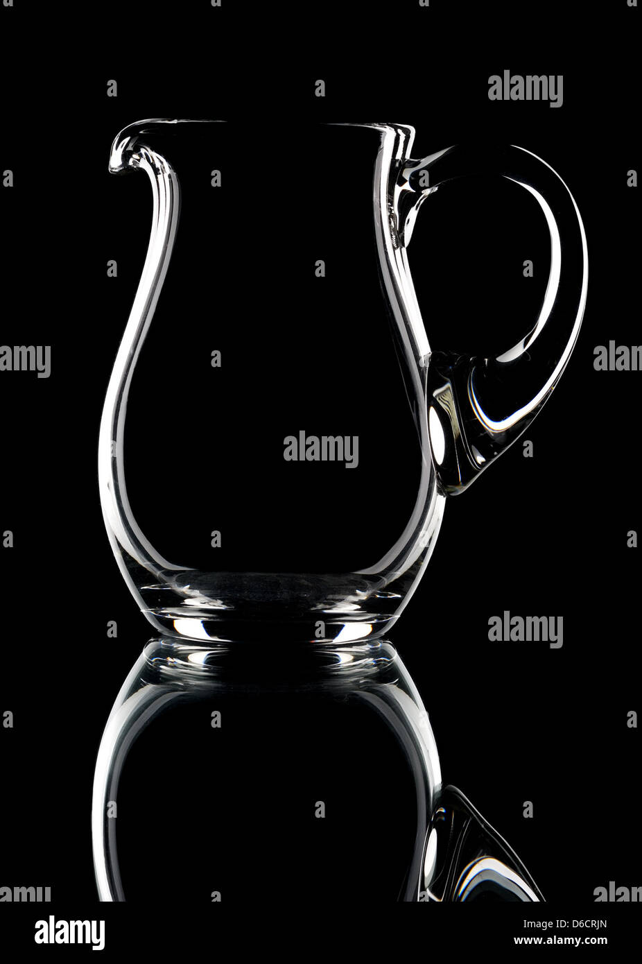 Glass pitcher on a black background Stock Photo - Alamy