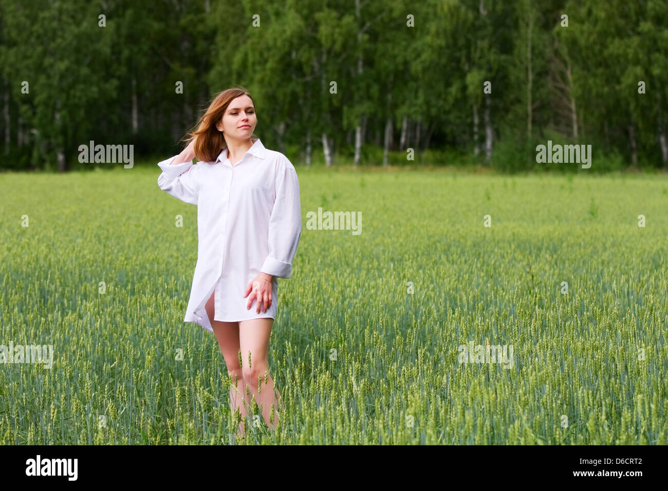 Young woman walking in a field Stock Photo - Alamy