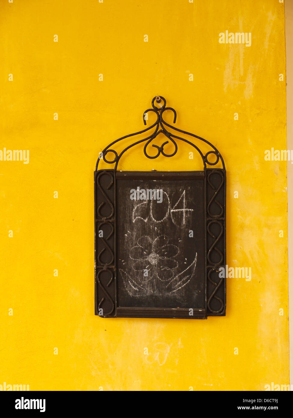 Blank board on yellow wall Stock Photo - Alamy