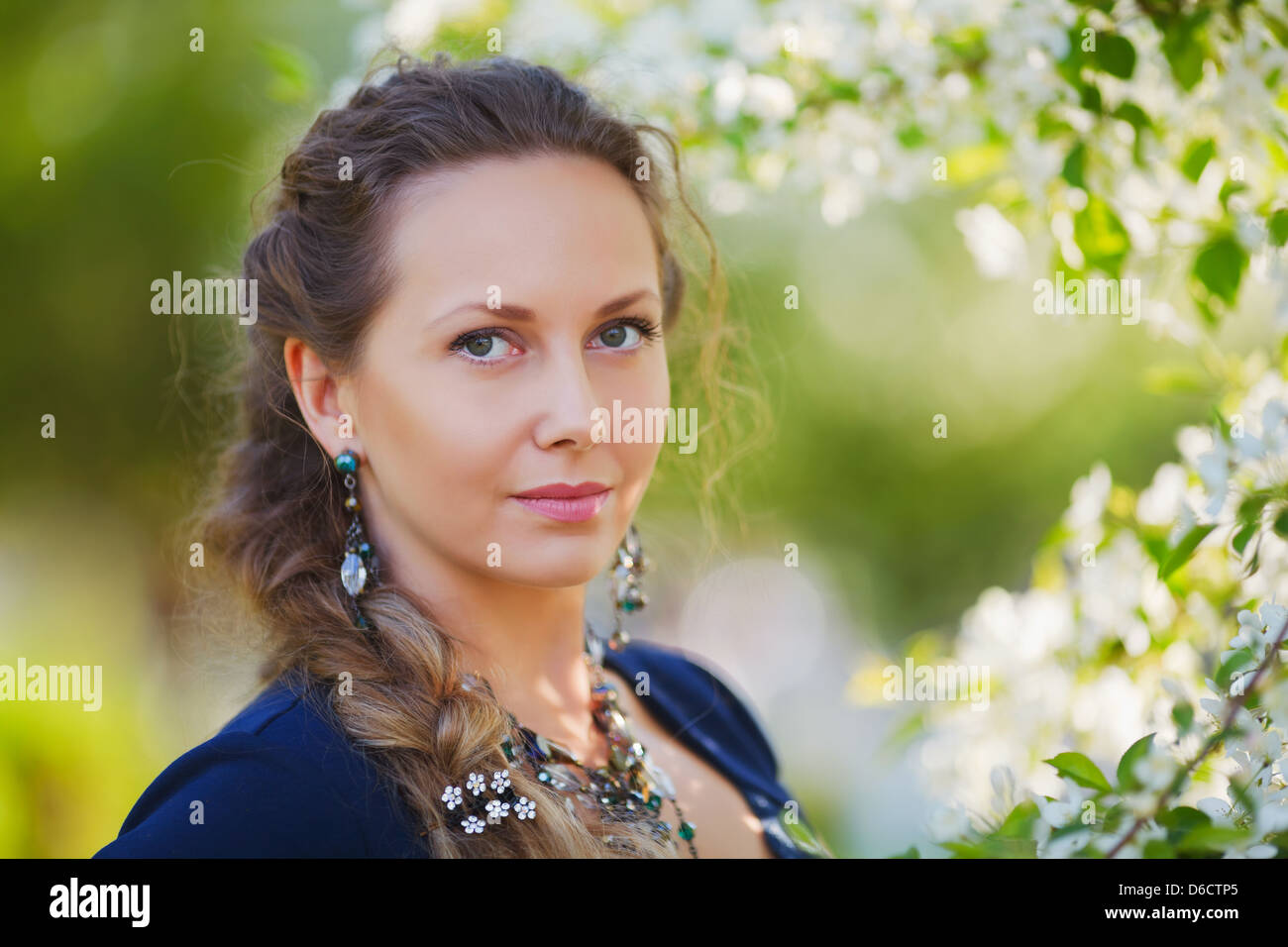 Beautiful woman in a spring garden Stock Photo - Alamy