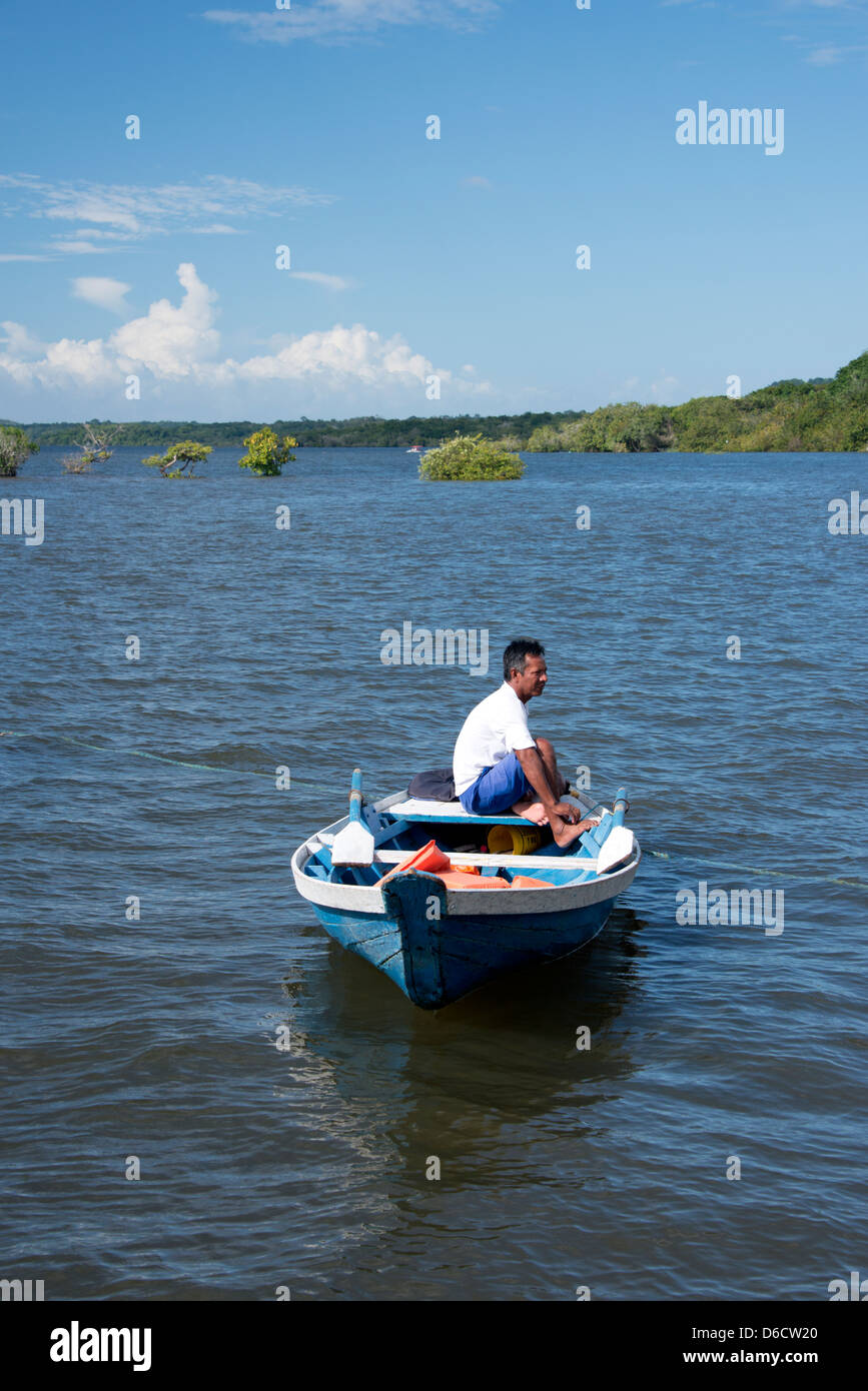 Brazil, Amazon, Alter Do Chao. Man in local fishing boat Stock Photo ...