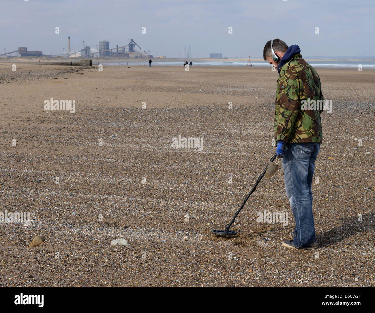 A man treasure hunting on the beach Stock Photo - Alamy