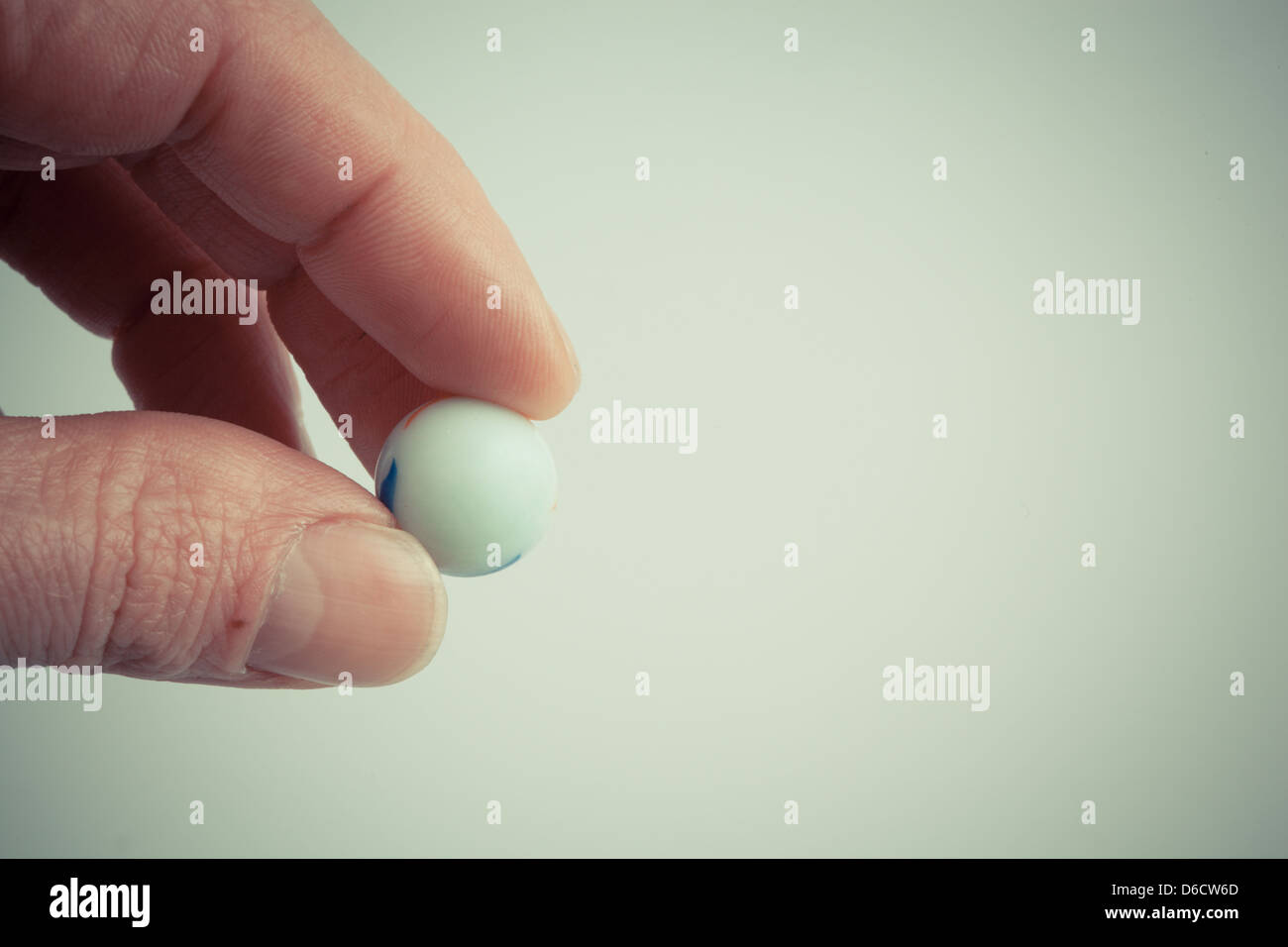 Hand holding marbles hi-res stock photography and images - Alamy