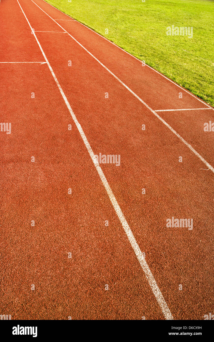 green grass and running track Stock Photo - Alamy