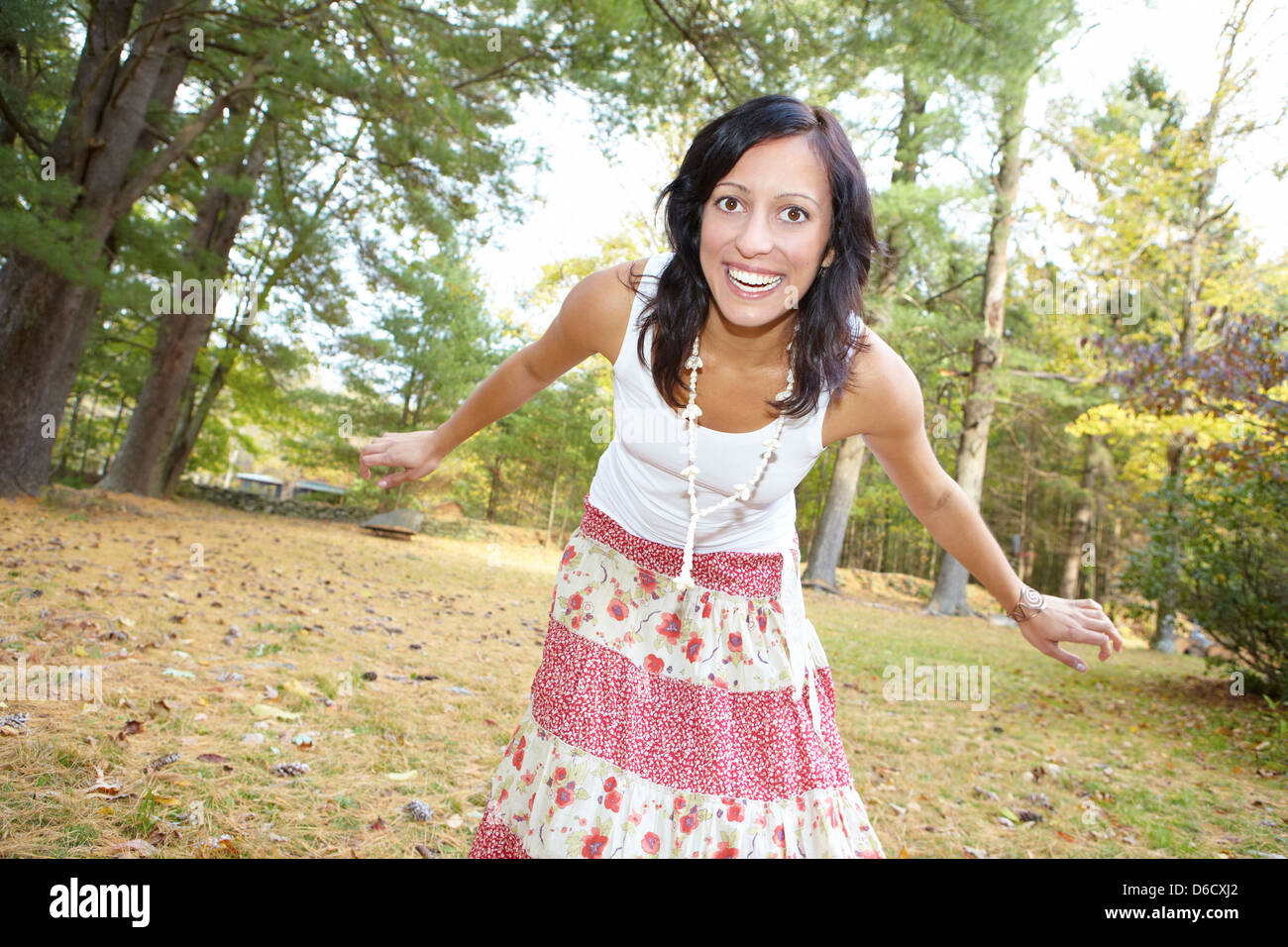 Girl running around in autumn countryside Stock Photo - Alamy