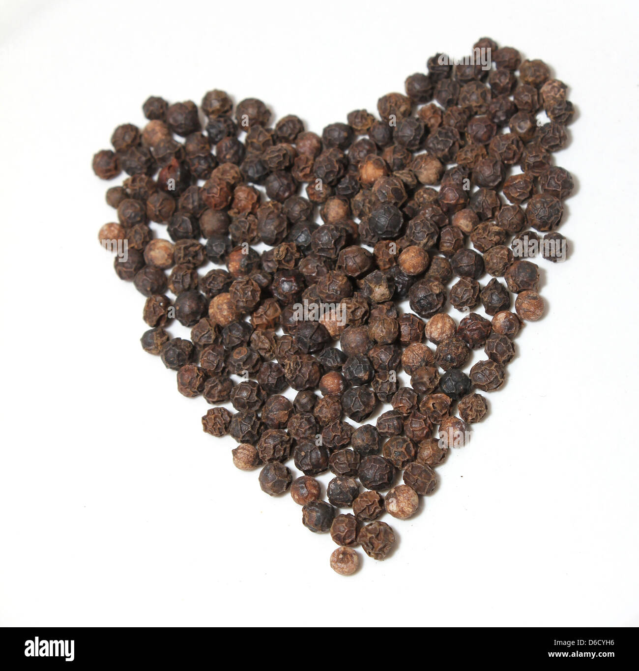 pepper corns isolated heart Stock Photo - Alamy