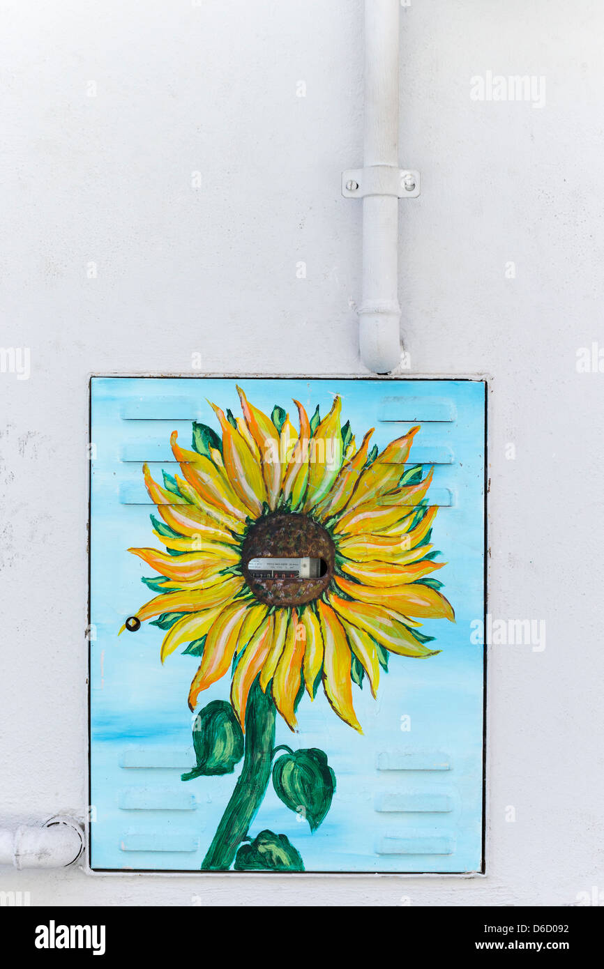 A gas meter cupboard painted to look like a sunflower, with the meter ...