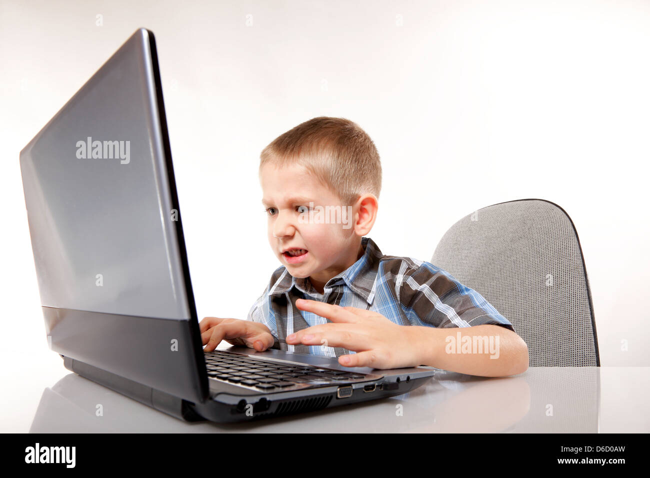 Computer addiction emotional child boy with laptop notebook playing ... Computer addiction emotional child boy with laptop notebook playing ...