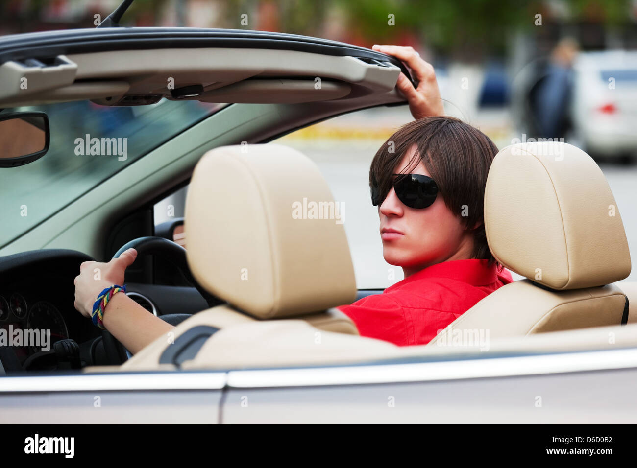 Young man driving a convertible car Stock Photo - Alamy