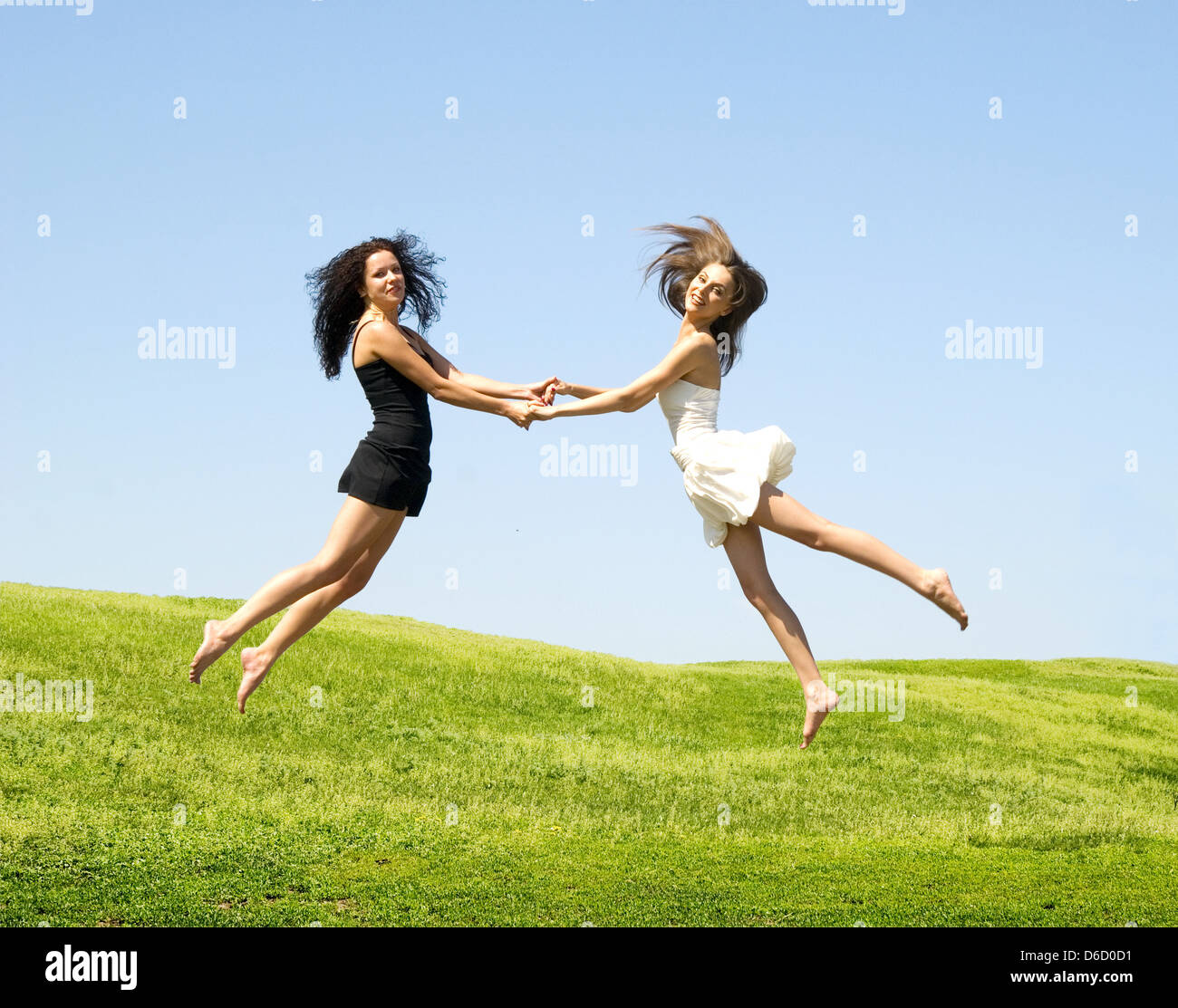 two jumping woman Stock Photo - Alamy