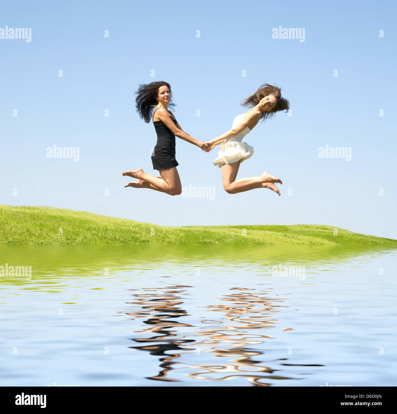 two jumping woman Stock Photo - Alamy