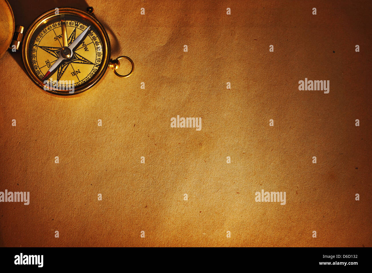 Antique brass compass over old background Stock Photo - Alamy