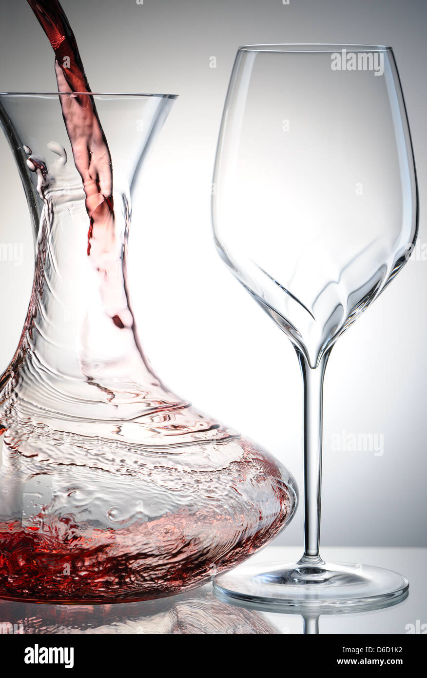 Pouring wine into decanter Stock Photo - Alamy