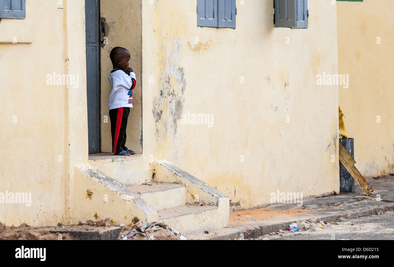 A small African boy standing on a step and waiting Stock Photo - Alamy