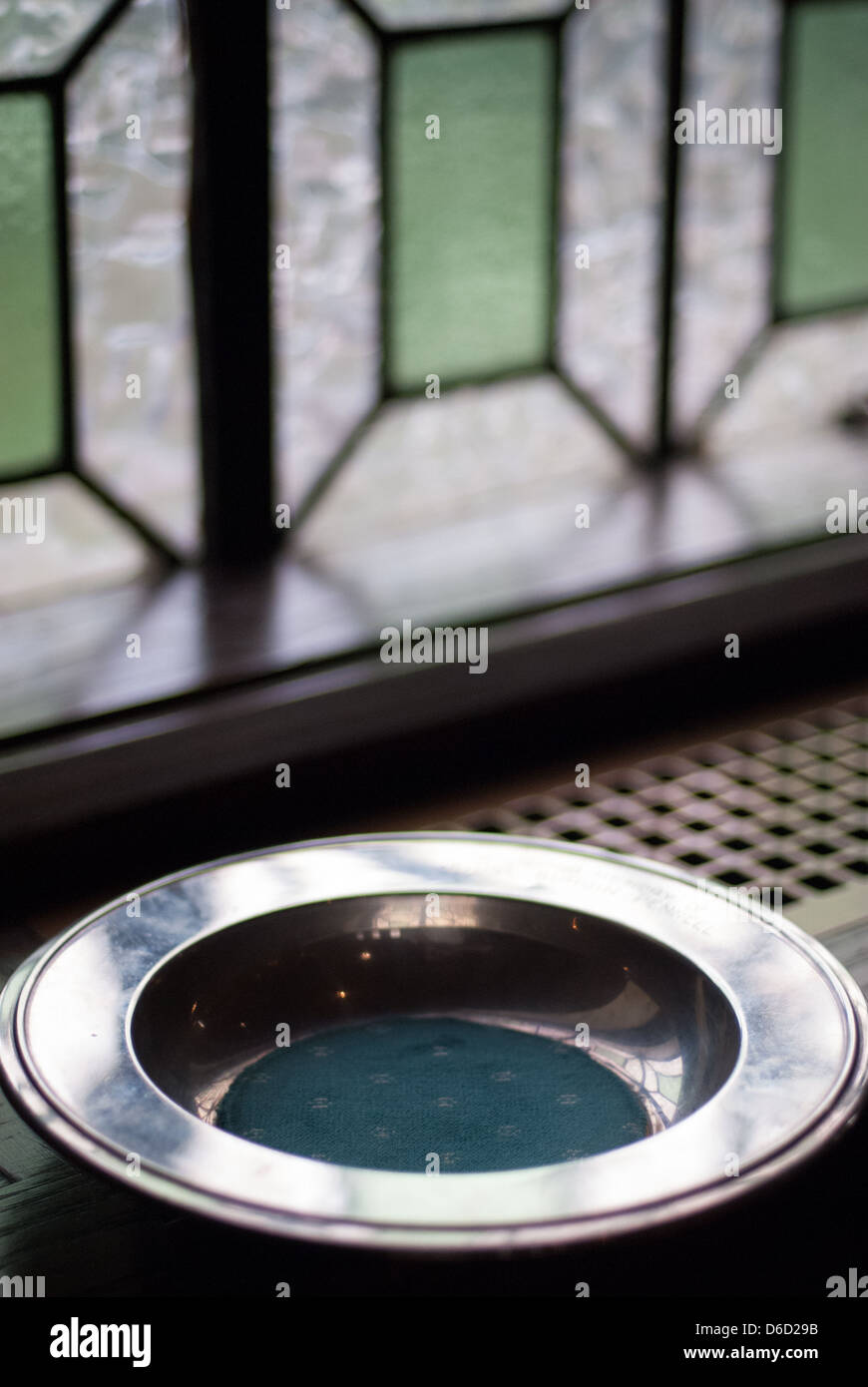 An offering plate in a place of worship Stock Photo - Alamy