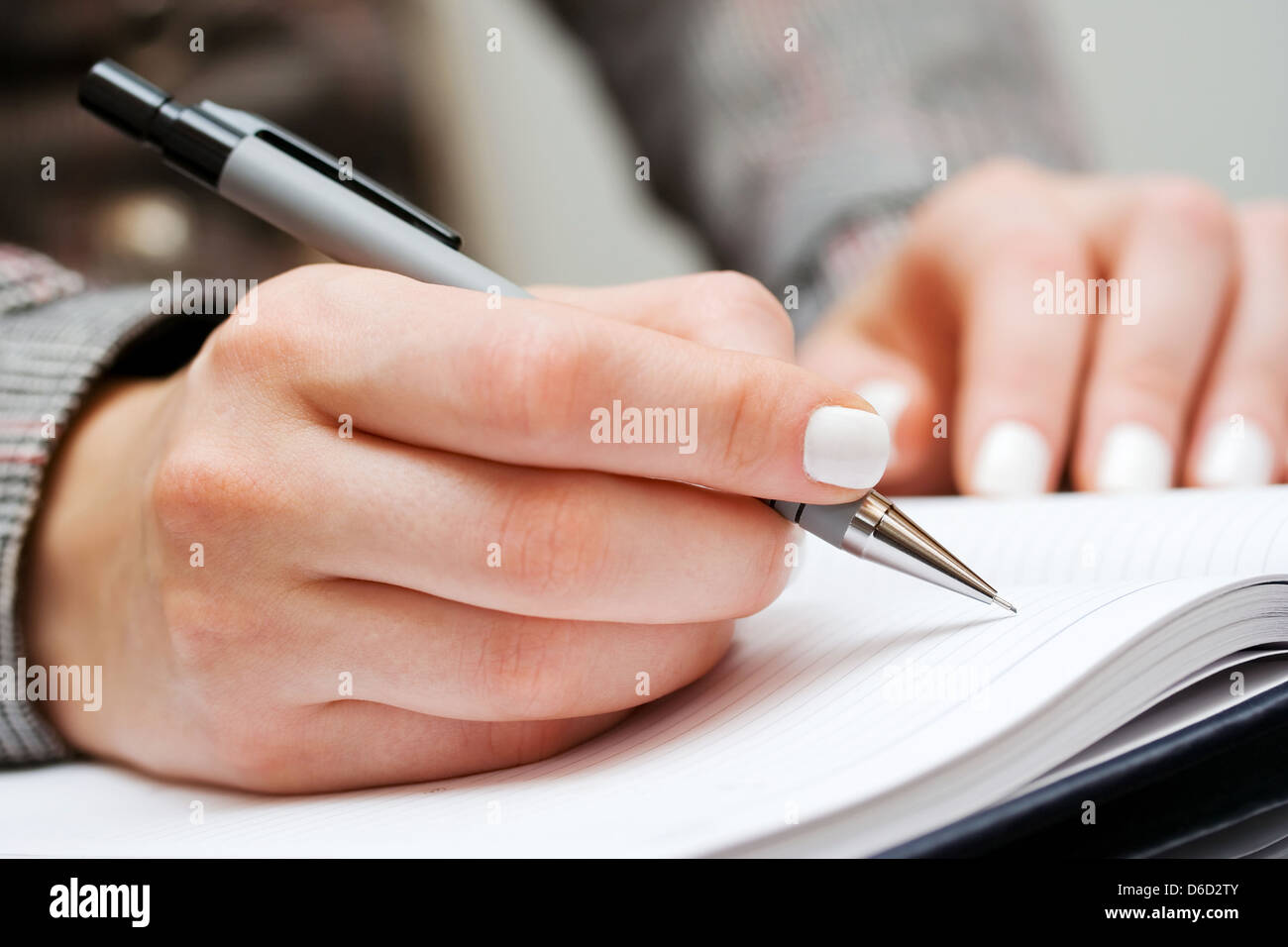 Female hand writing Stock Photo - Alamy