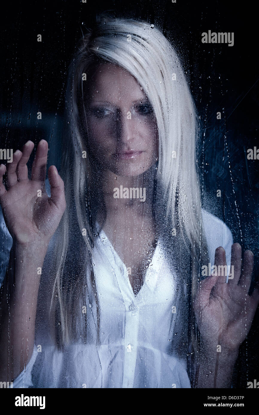 woman behind a rainy window Stock Photo - Alamy