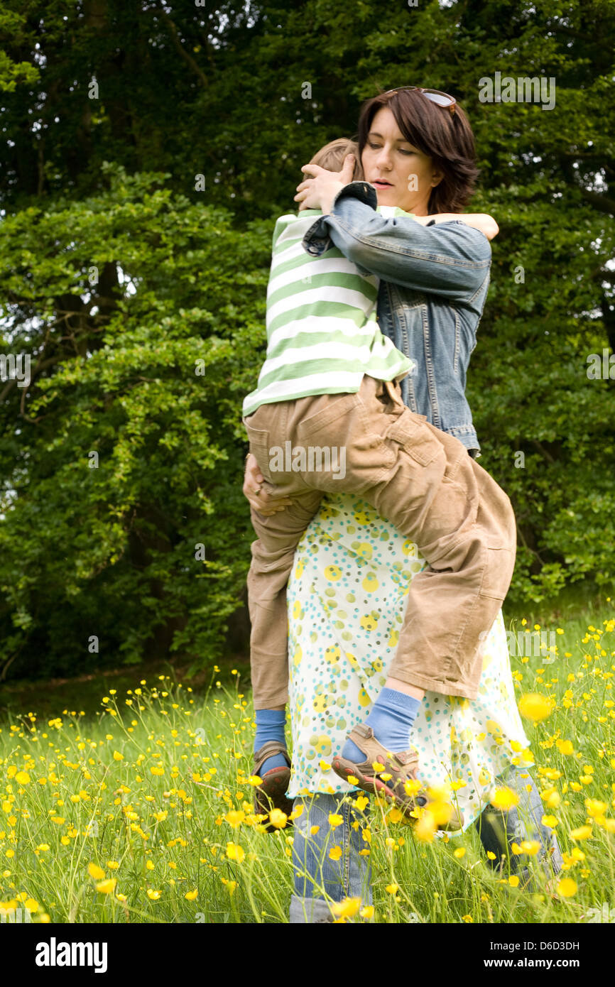 Potsdam, Germany, weeping mother carries son in a flower meadow Stock ...