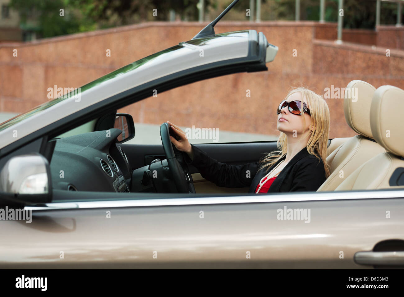 Young woman driving a convertible car Stock Photo - Alamy