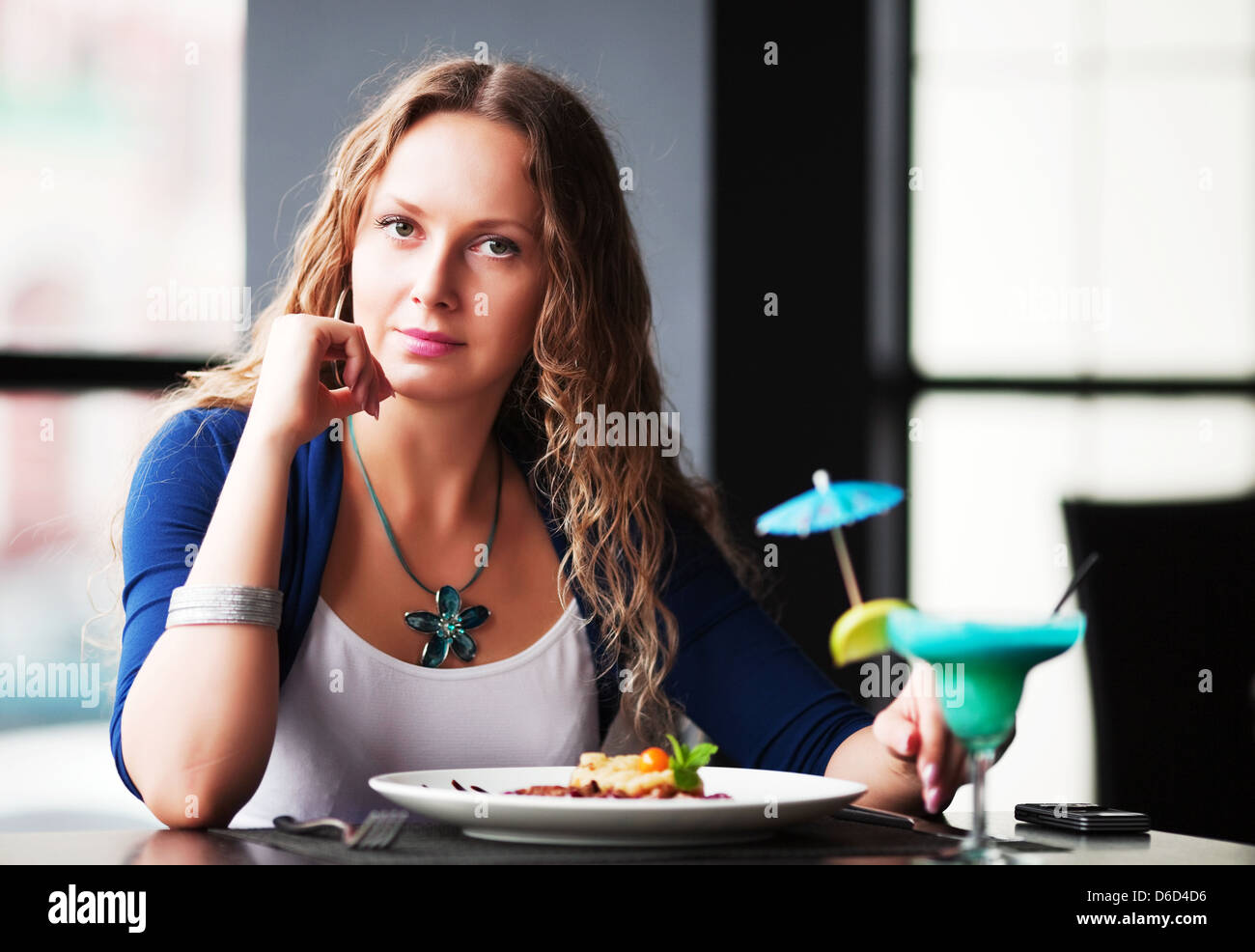 Beautiful young woman dining Stock Photo - Alamy