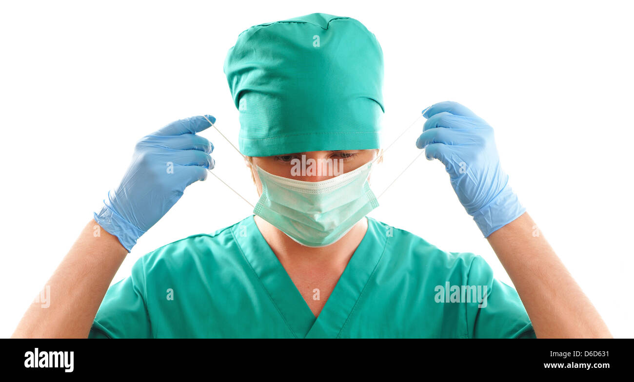 Pulling on surgical mask Stock Photo - Alamy