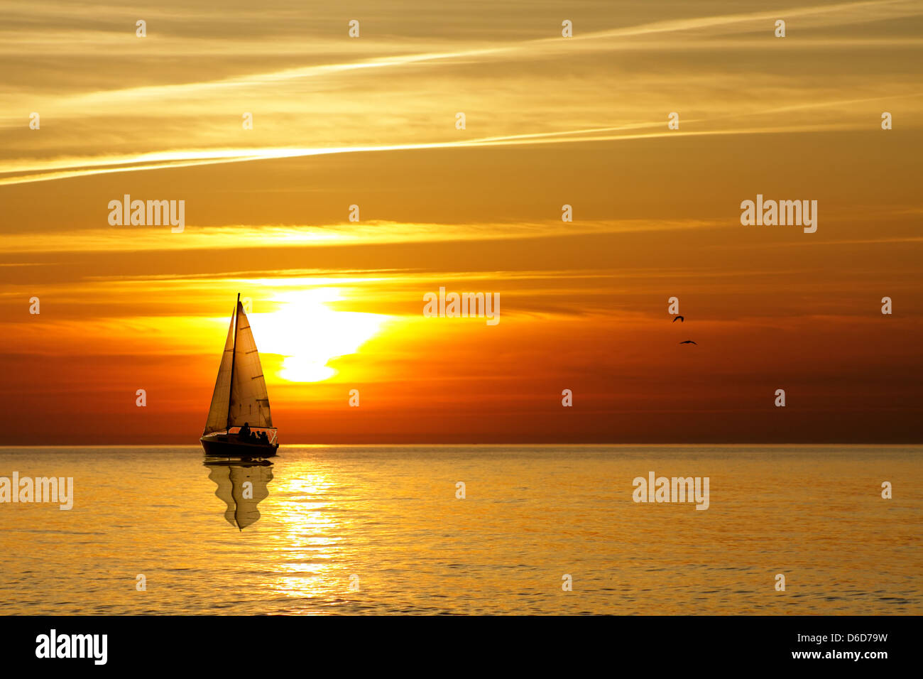 Sailing at sunset Stock Photo - Alamy