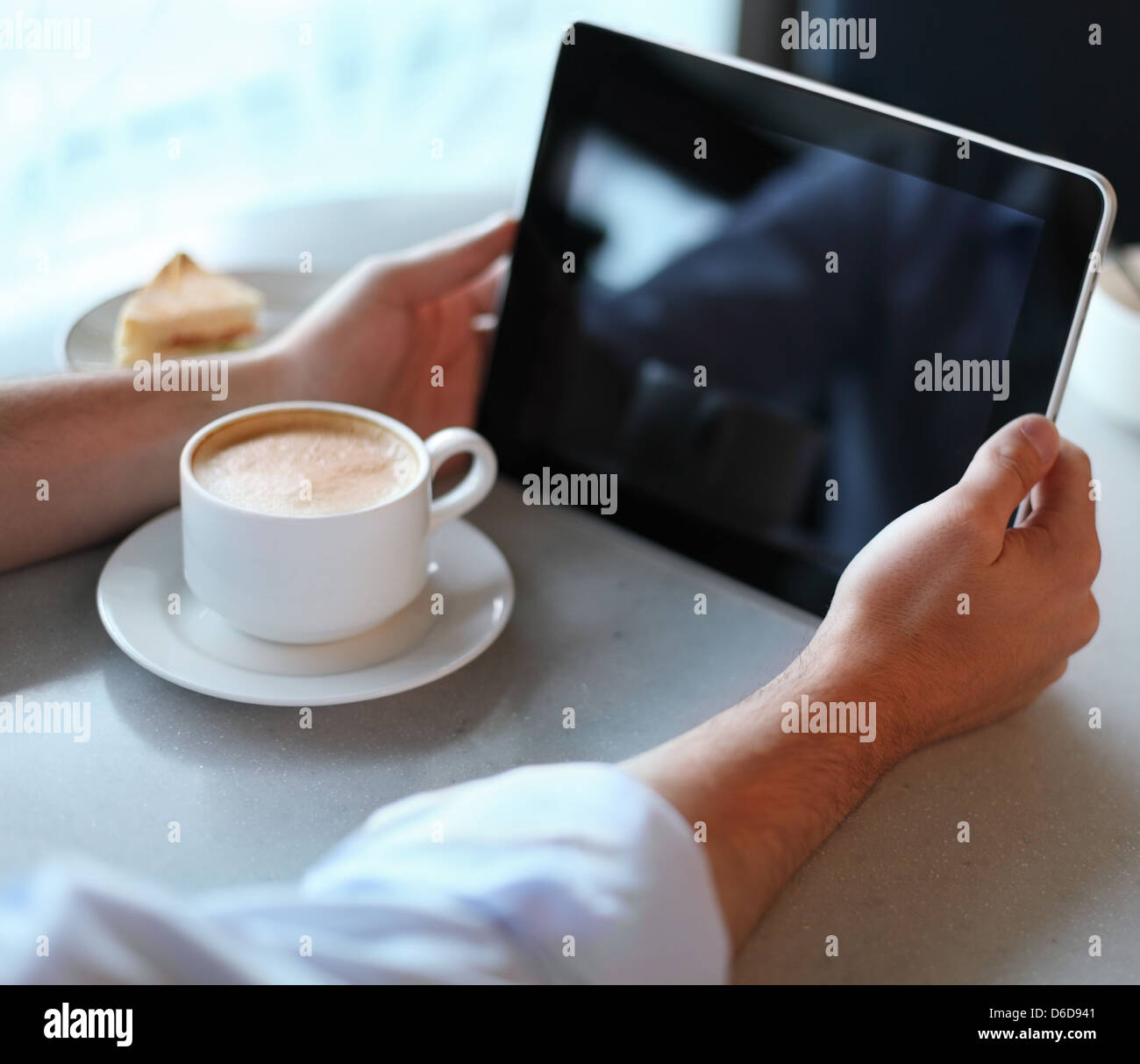 Man holding tablet computer in cafe Stock Photo - Alamy