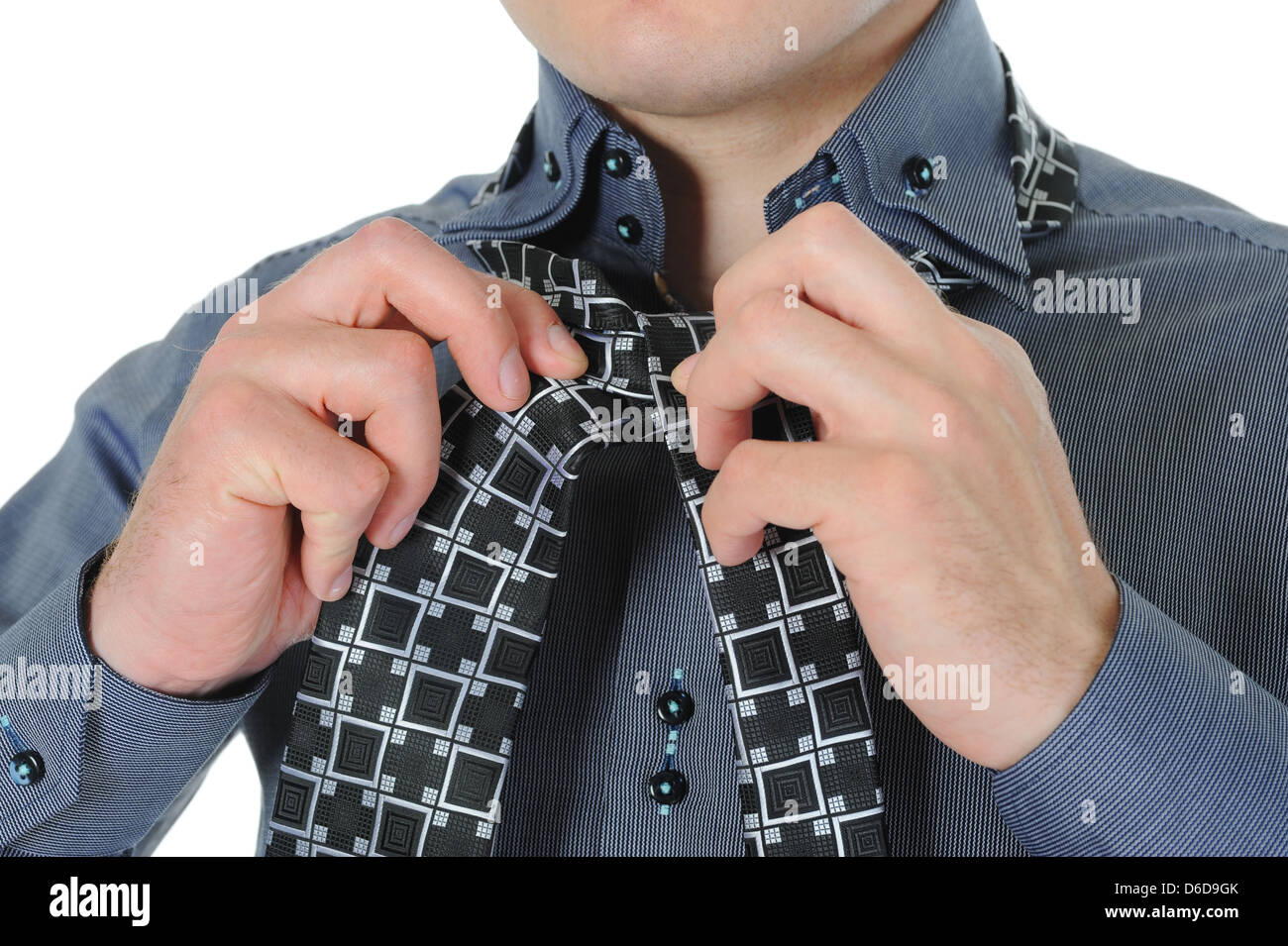 Businessman tying his tie Stock Photo - Alamy