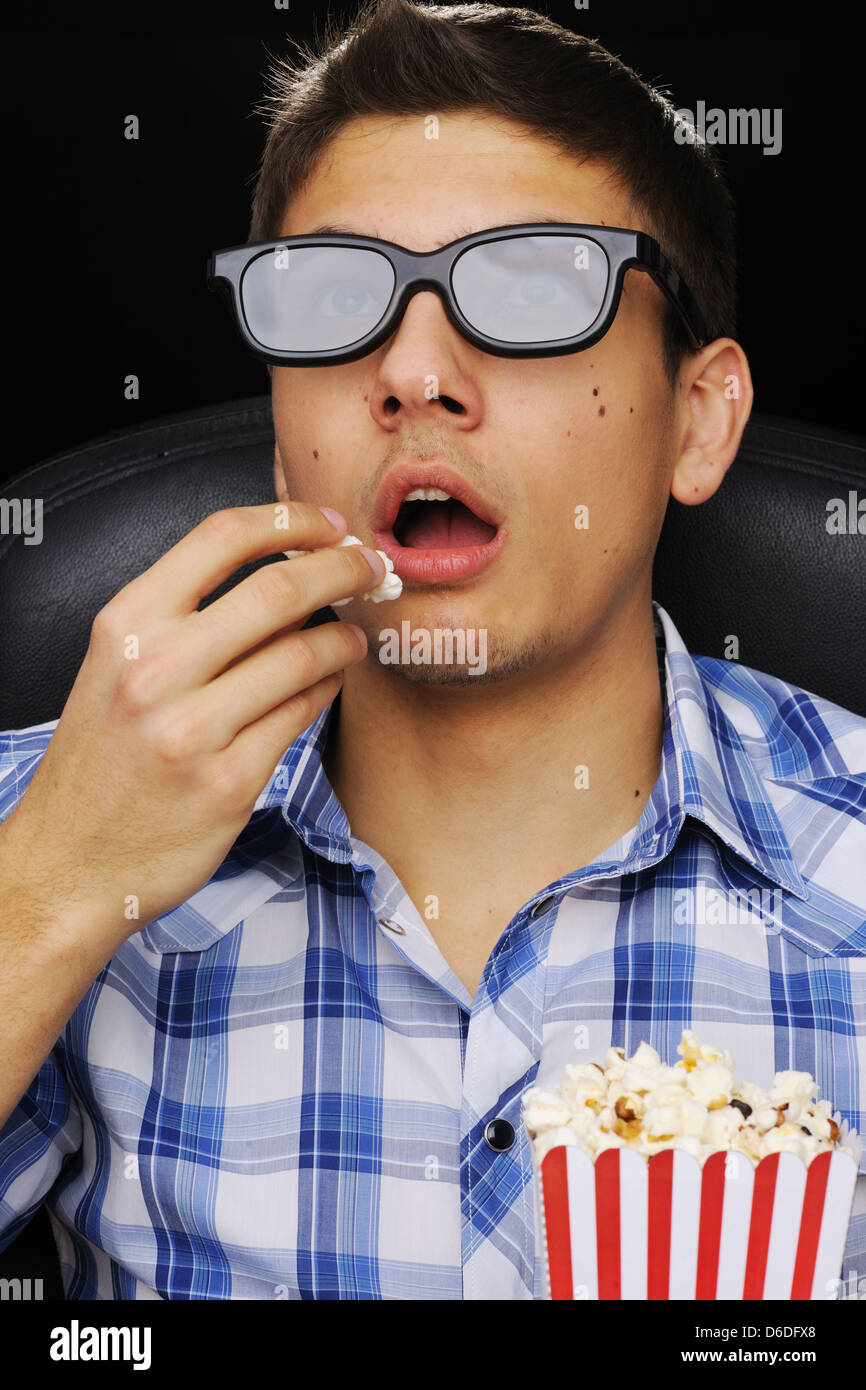 Young man at cinema Stock Photo - Alamy