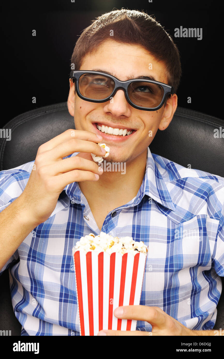 Young man at cinema Stock Photo - Alamy