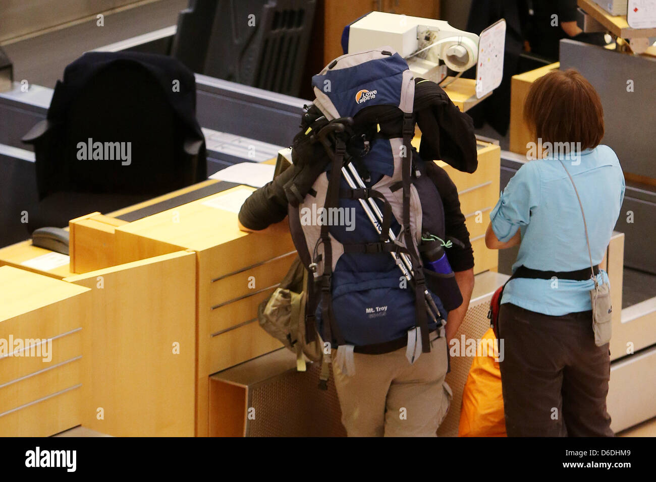 Passengers stand at an empty check-in counter of Lufthansa at Hamburg ...