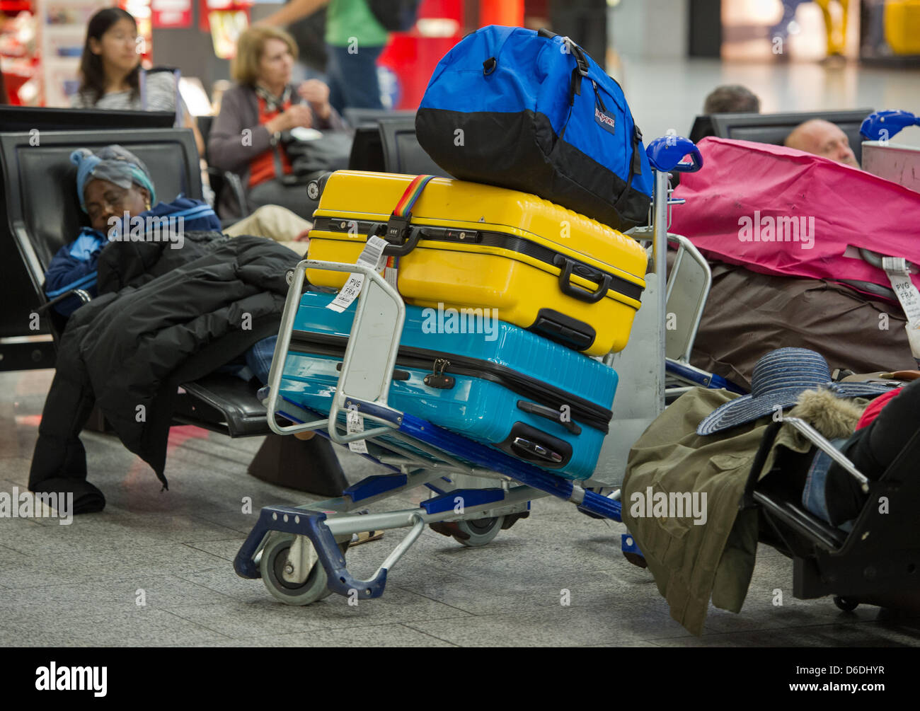 Passengers sleep on benches next to their luggage at a terminal of the ...