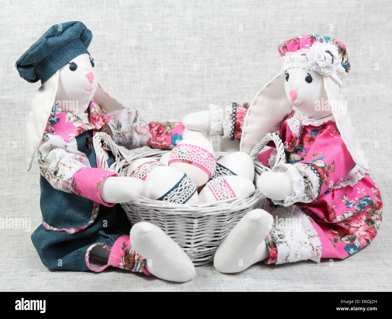 Two Easter Bunnies with Basket of Decorated Eggs Stock Photo - Alamy