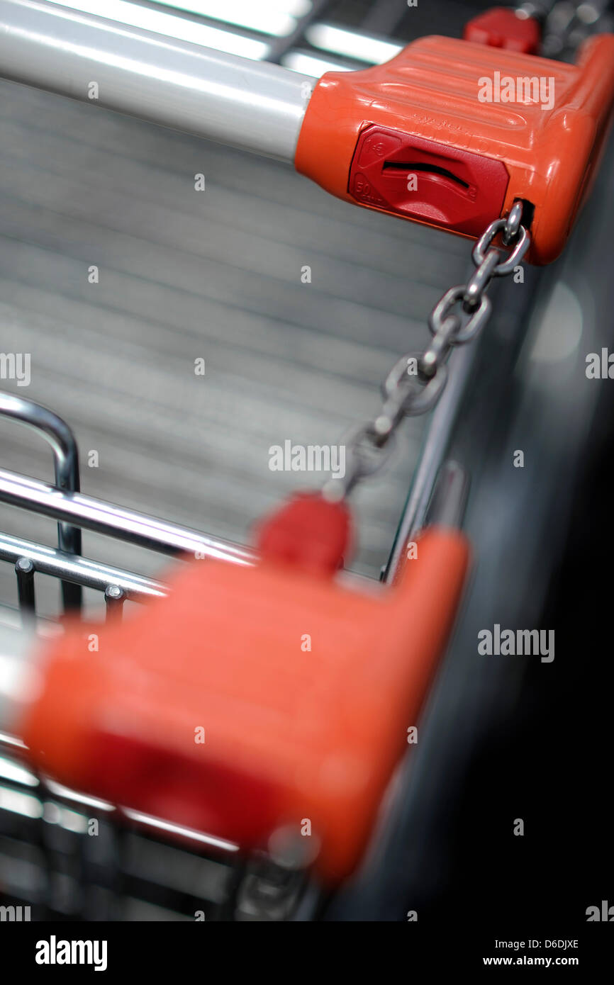 Shopping carts are chained to each other on the parking lot of a ...