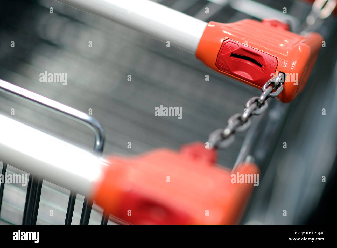 Shopping carts are chained to each other on the parking lot of a ...