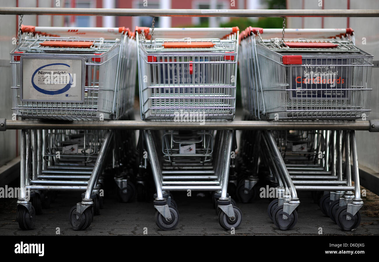 Shopping carts are chained to each other on the parking lot of a ...