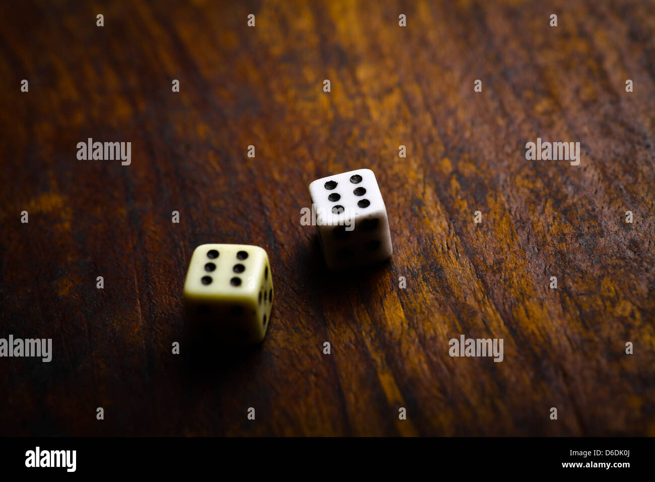 Two dice displaying six on a vintage wood plank Stock Photo - Alamy