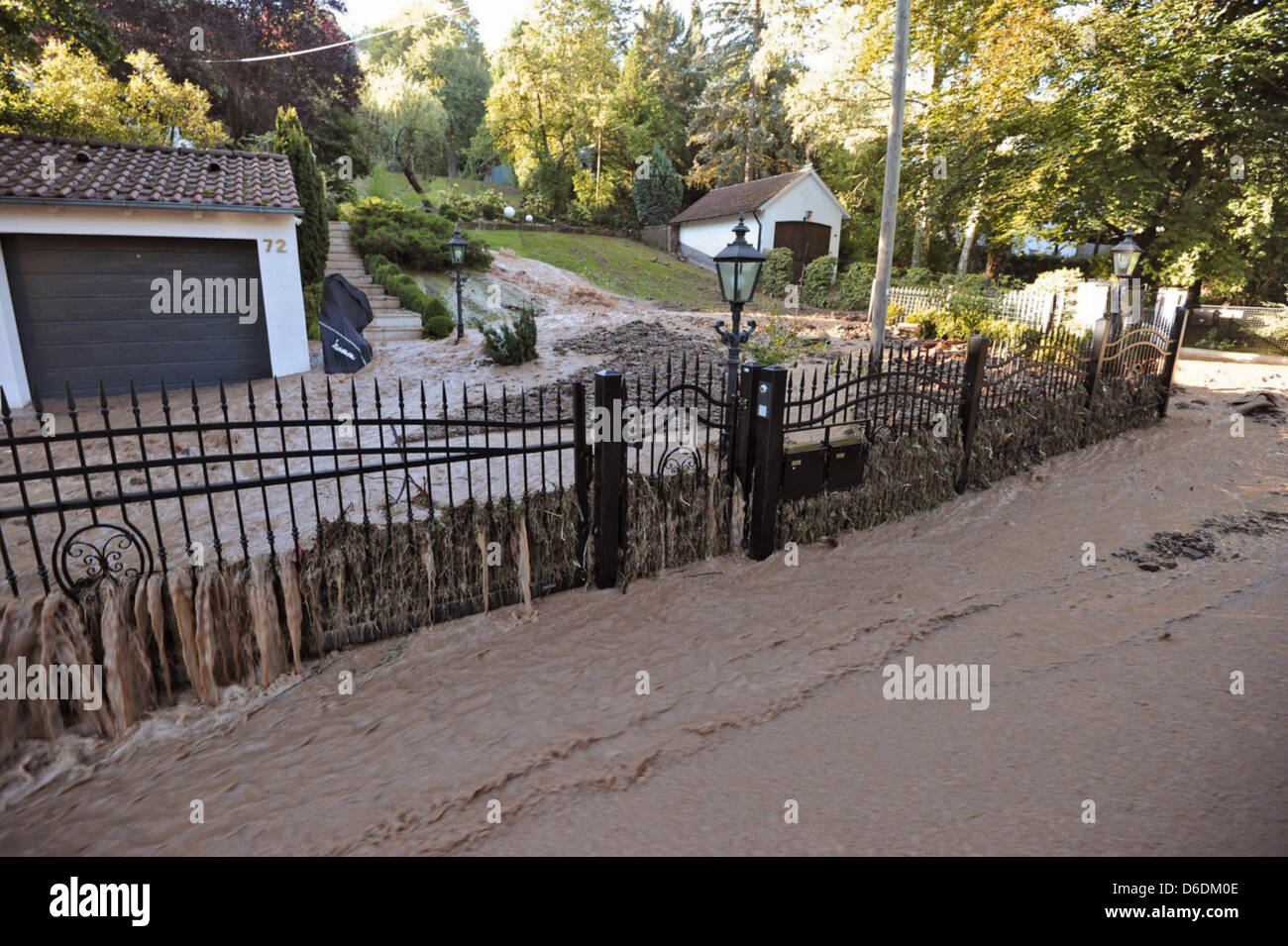 Mud and water slides through a street after a water-pipe burst in ...