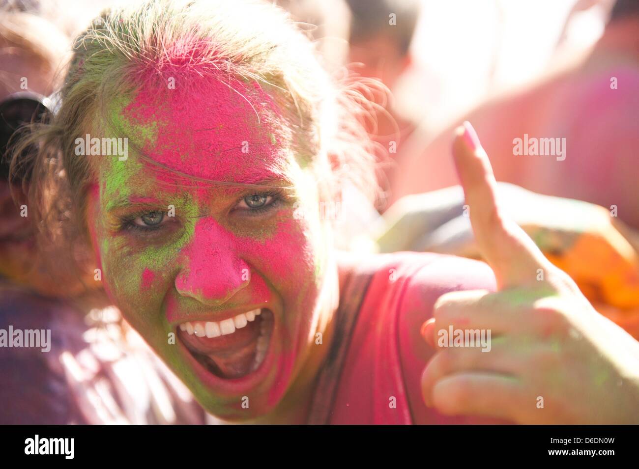 Julia (21) gestures as her face is covered in colour pigments at the ...