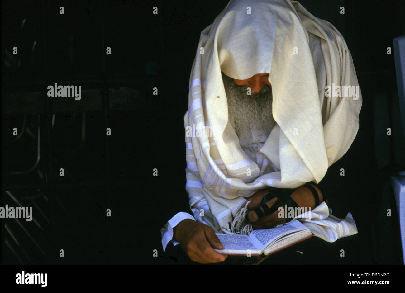 A religious Jew wrapped with Tefillin phylacteries and Talit prayer ...