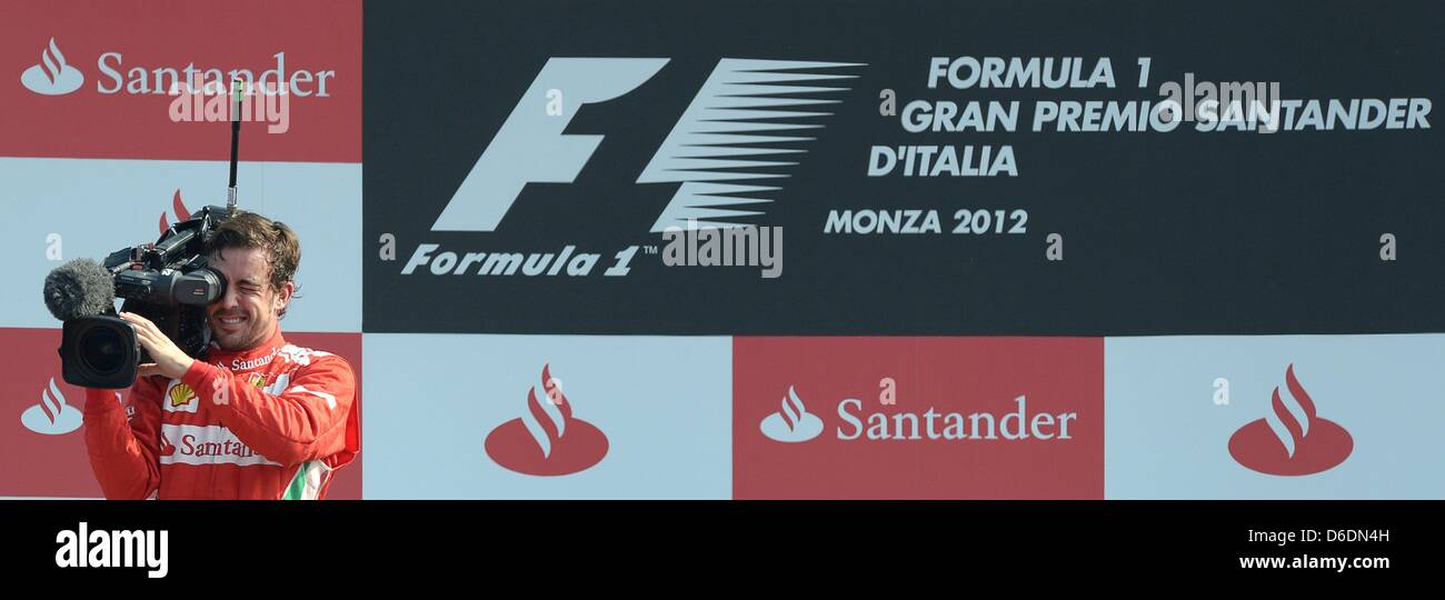 Spanish Formula One driver Fernando Alonso of Ferrari films the Tifosi ...