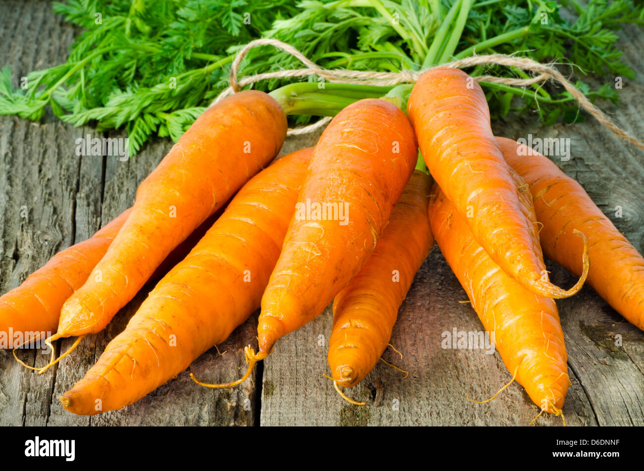 fresh carrots bunch on wood Stock Photo - Alamy