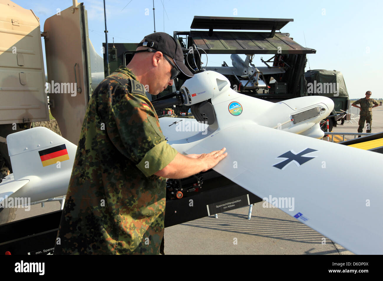 A soldier of the German armed forces stands next to a 'Luna' drone ...