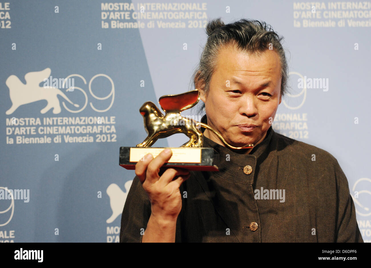 South Korean Director Kim Ki-duk shows his Golden Lion award for his ...