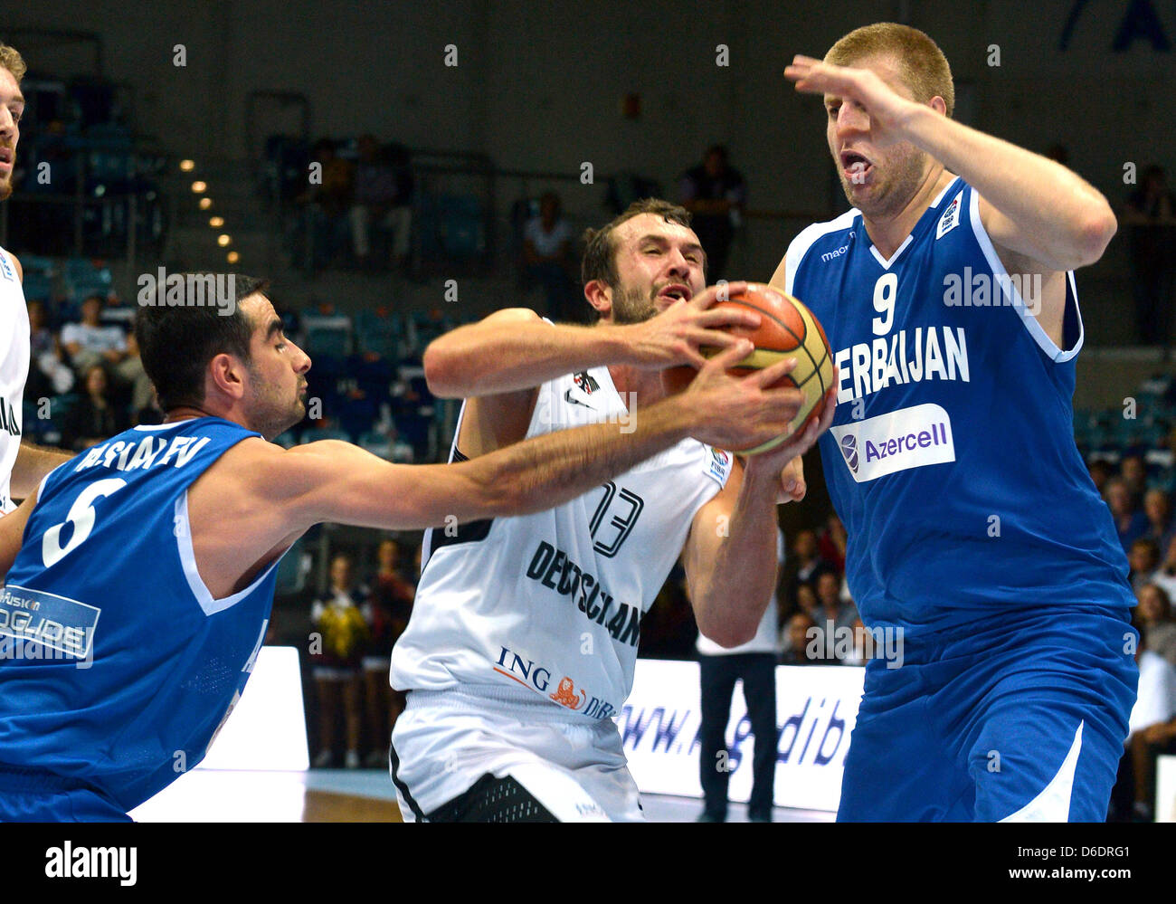 Germany's national basketball player Bastian Doreth (C) and Azerbaijan ...
