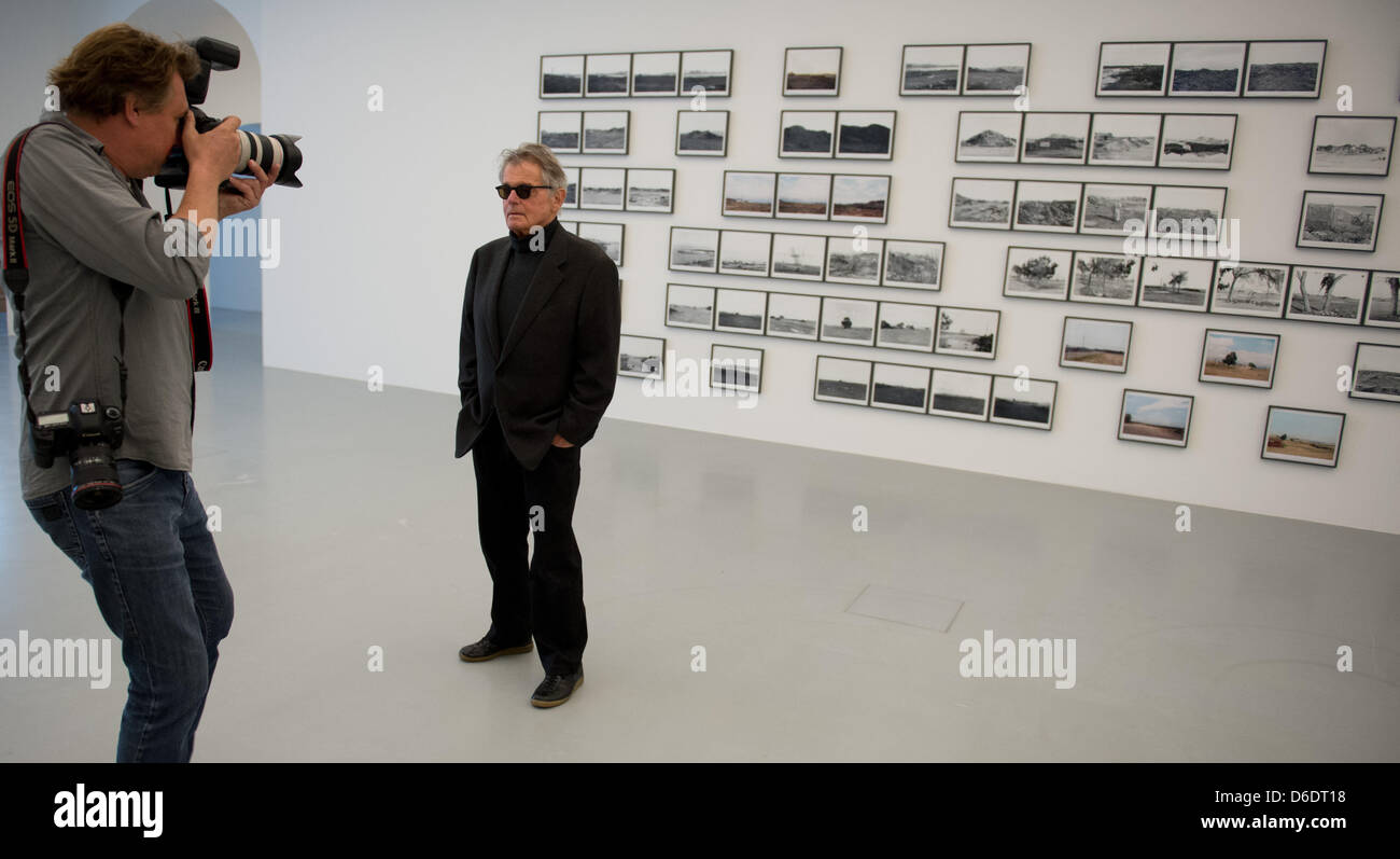 American photographer Lewis Baltz (R) poses in front of a photo collage ...