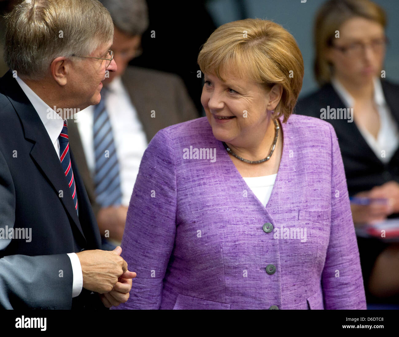 German Chancellor Angela Merkel and State Secretary Peter Hintze attend ...