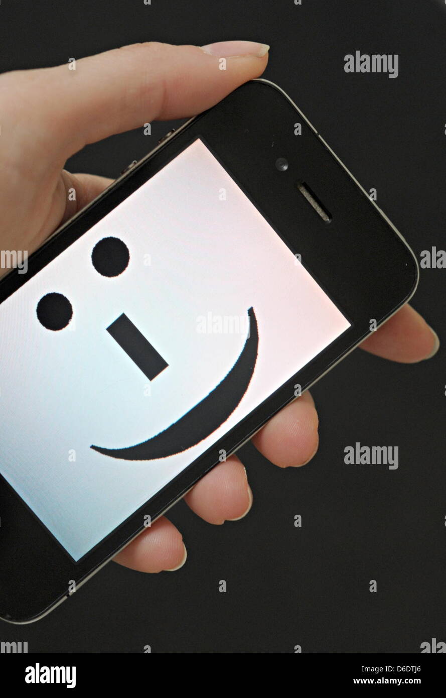 The illustration shows a smartphone with a smiley on display in ...