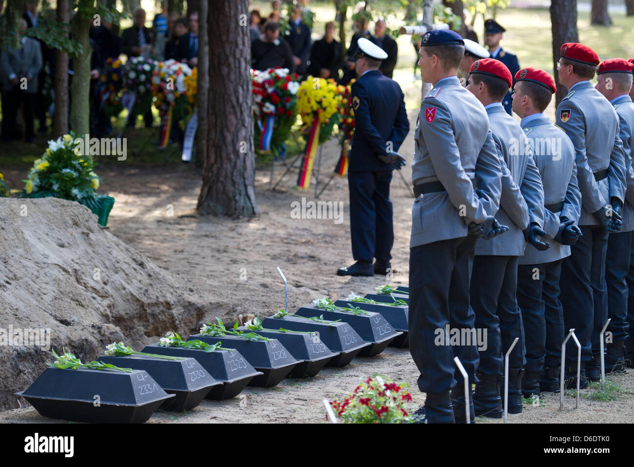 German soldiers stand behind coffins containing the mortal remains of ...