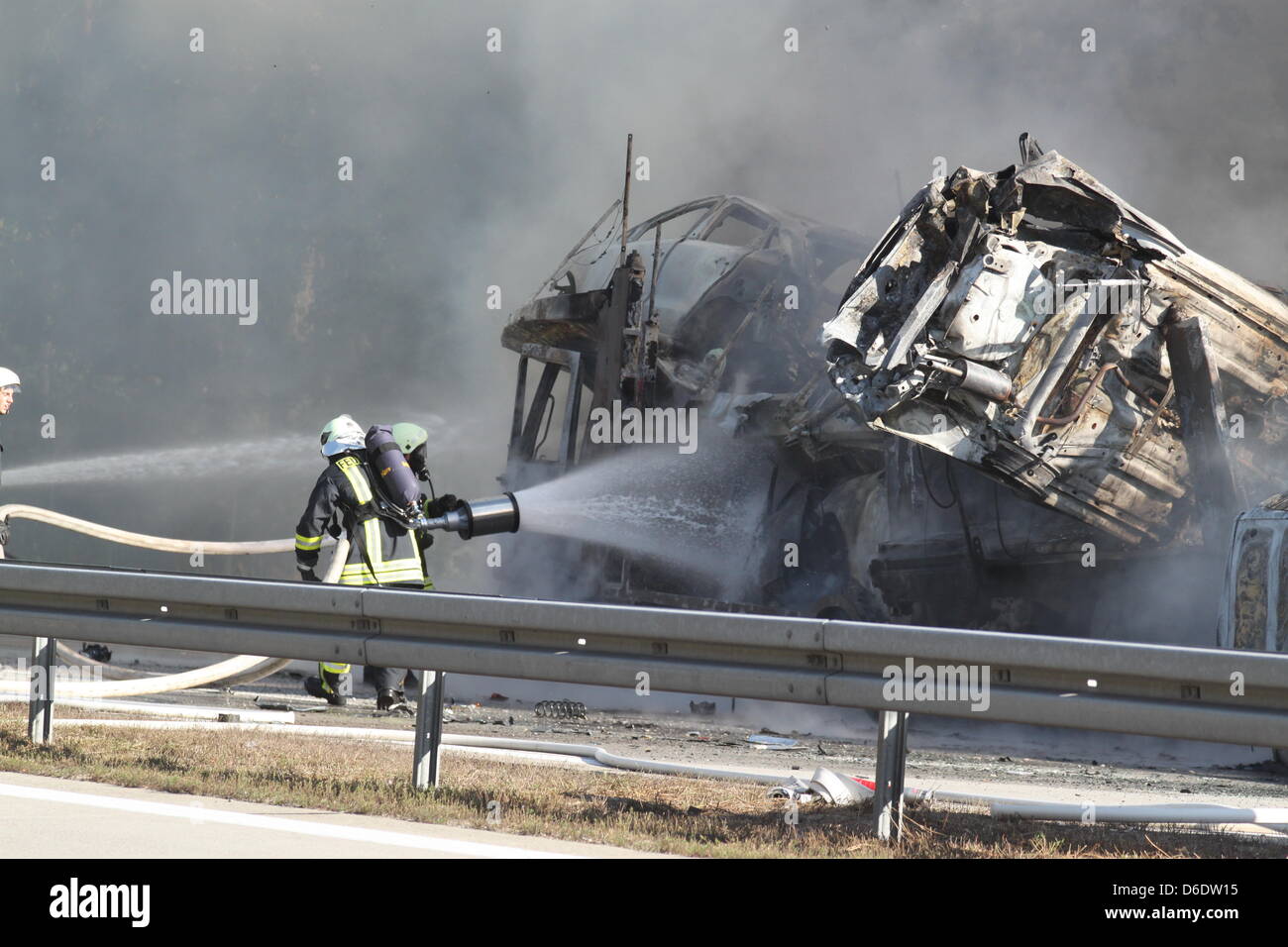 Fire fighters extinguish fire of a burning lorrey after a serious ...